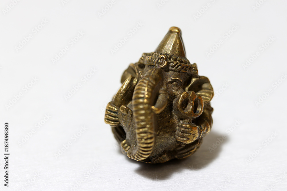 Mini Ganesha made from brass on white background, the son of Uma Devi ...