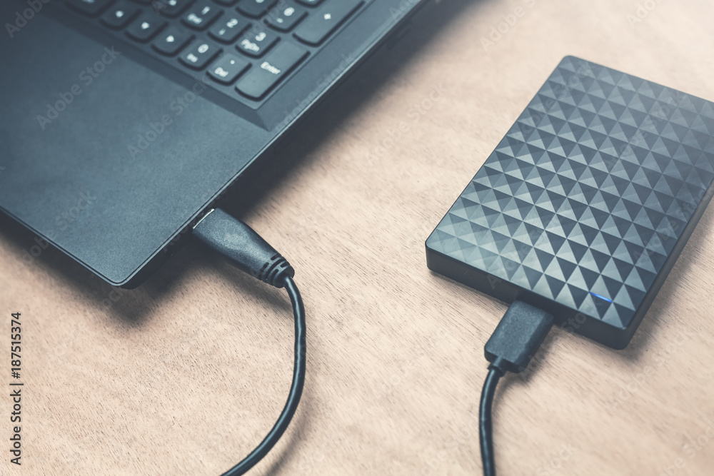 External hard drive connection on a laptop. Stock Photo | Adobe Stock