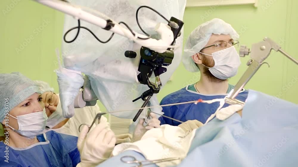 surgeons are removing swabs from larynx of patient in finish of ...