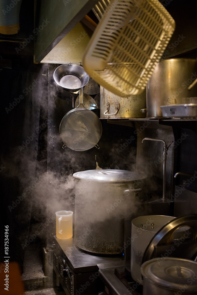 Steam, pots, and pans in the kitchen of a ramen restaurant in Japan ...
