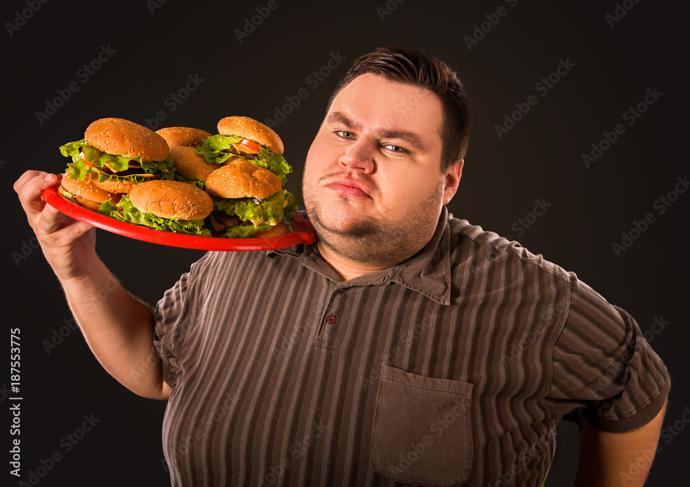 Diet failure of fat man eating fast food. Happy smile overweight person ...