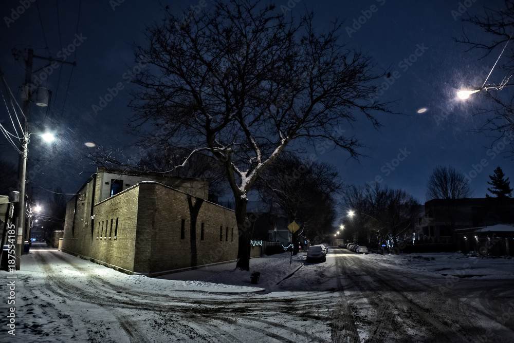 Dark, cold Chicago winter alley and street intersection with snow and ...