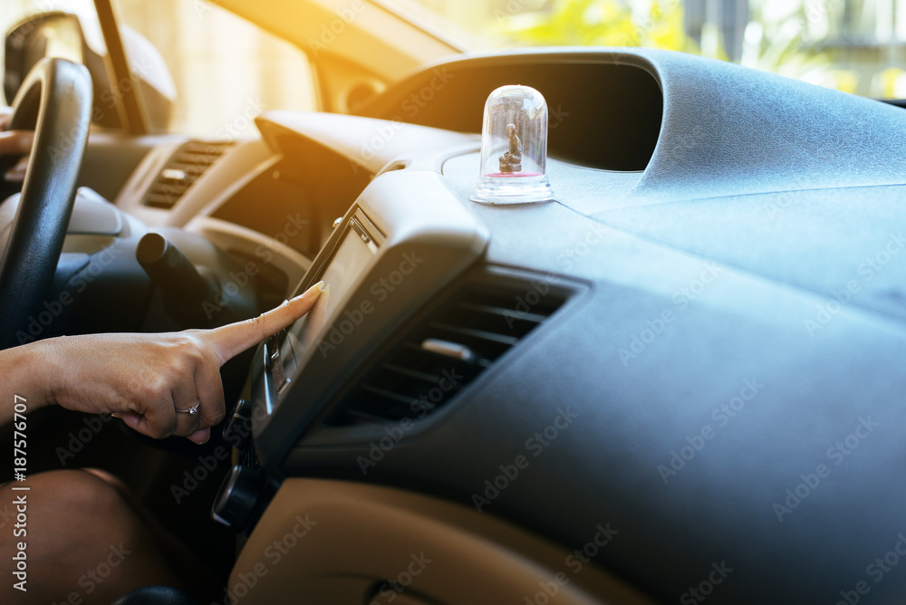 Hand touching the screen and turning on car radio system,Button on ...