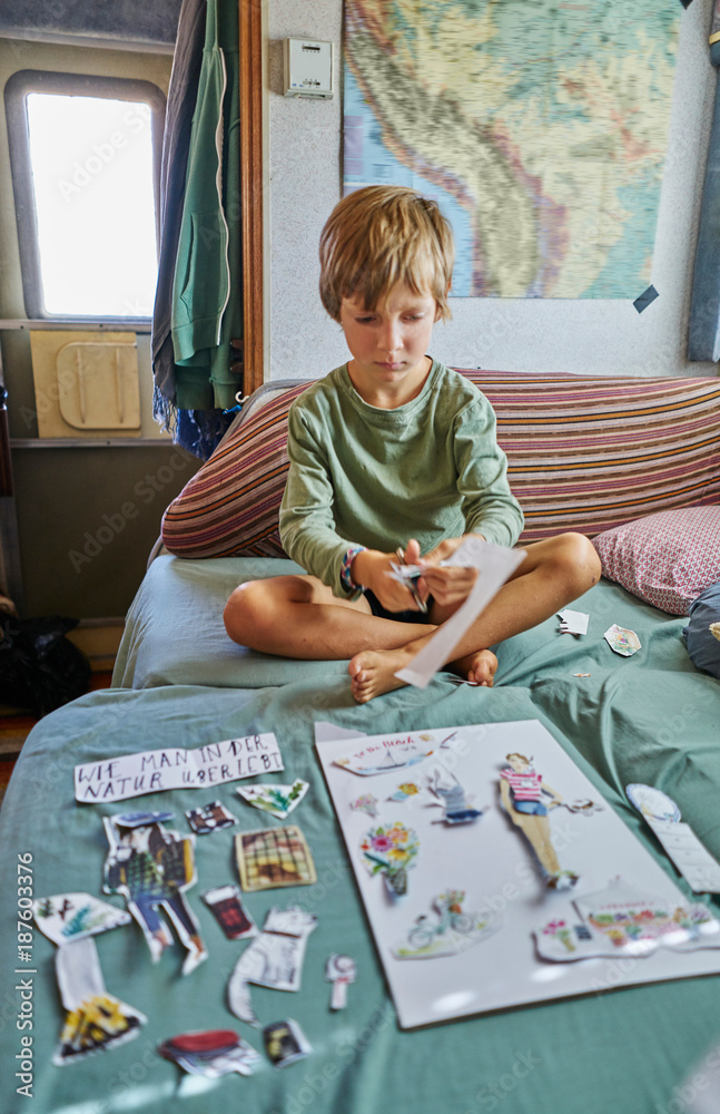 Boy cutting out pictures, Chuquisaca, Bolivia, South America Stock ...