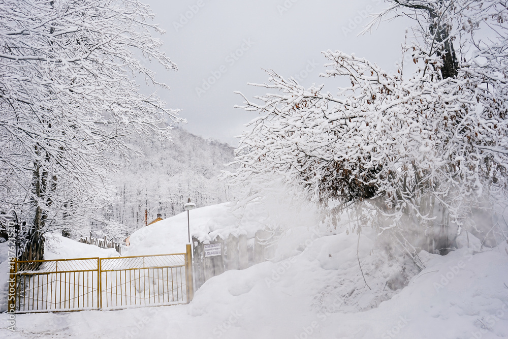 beautiful snow-covered mountain landscape with an iron fence Stock ...