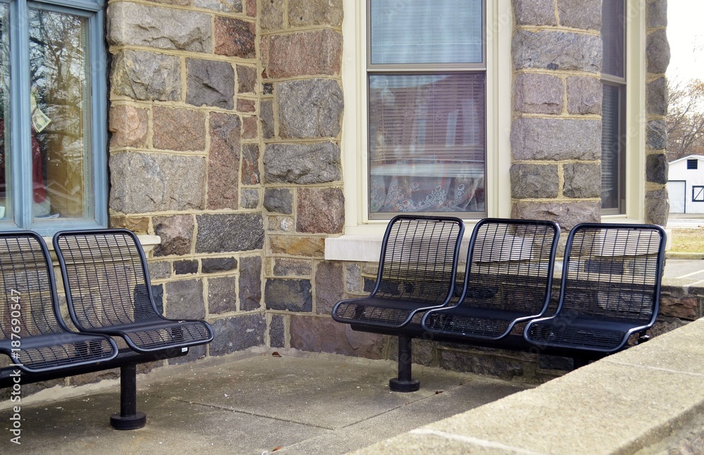 Metal mesh seats in a courtyard in the front of this vintage stone ...