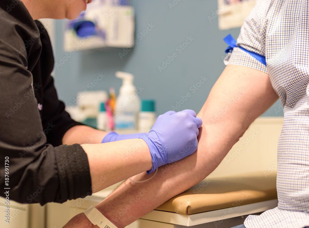 Nurse preparing for blood draw during routine health screening Stock ...