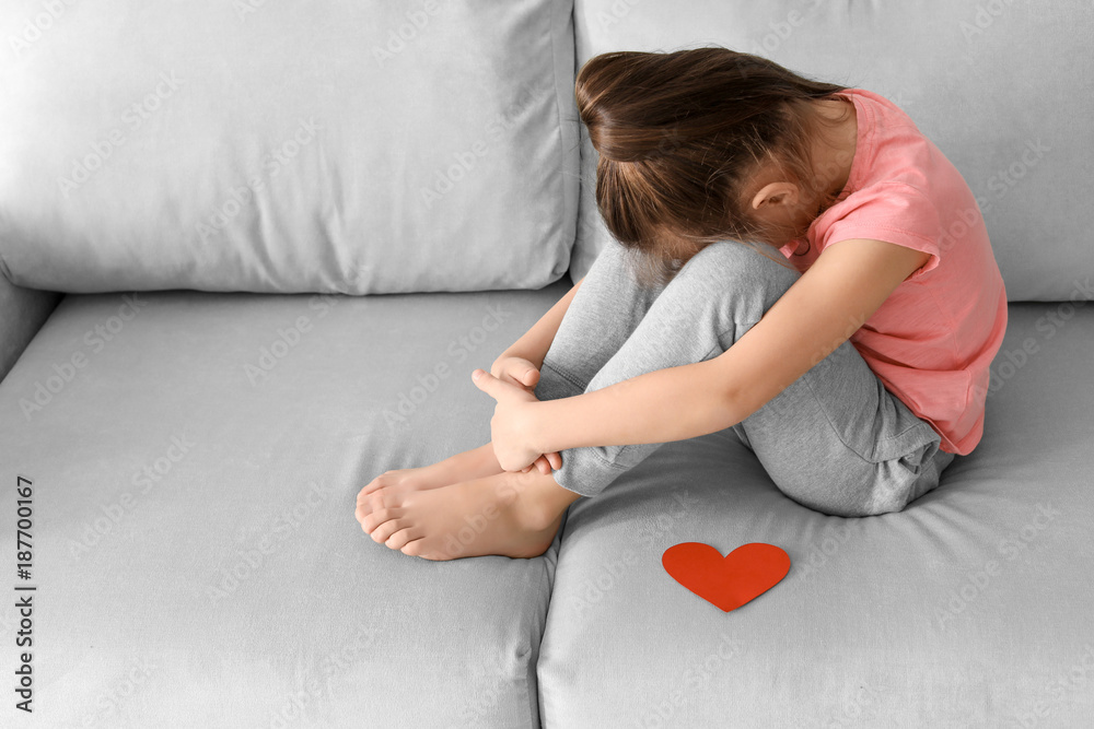 Little girl crying near paper heart at home. Child autism Stock Photo ...
