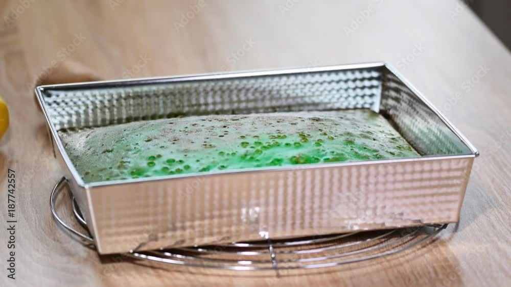 Green dough for preparation of pistachio biscuit cake in metal form for ...