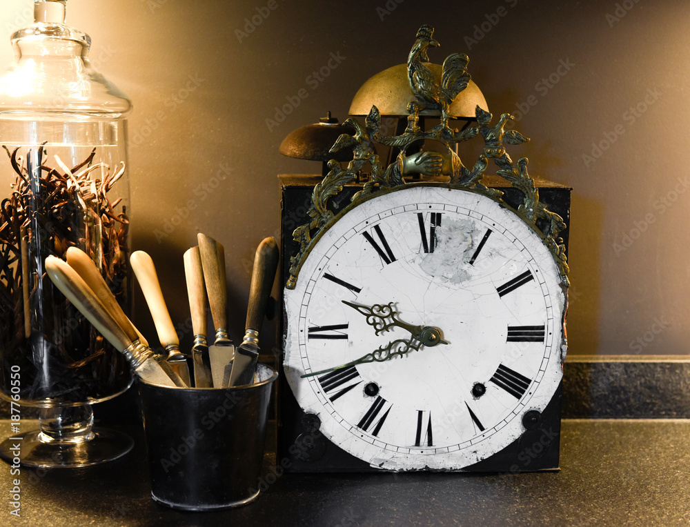Old clock with silverware and vanilla jar in a black kitchen Stock ...