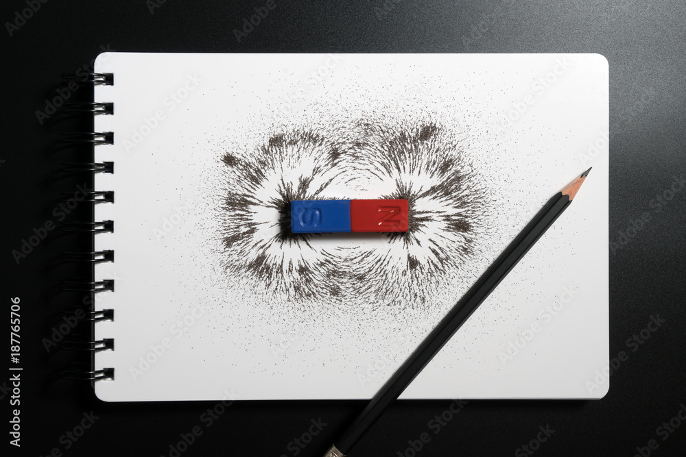 Red and blue bar magnet or physics magnetic, pencil and iron powder ...