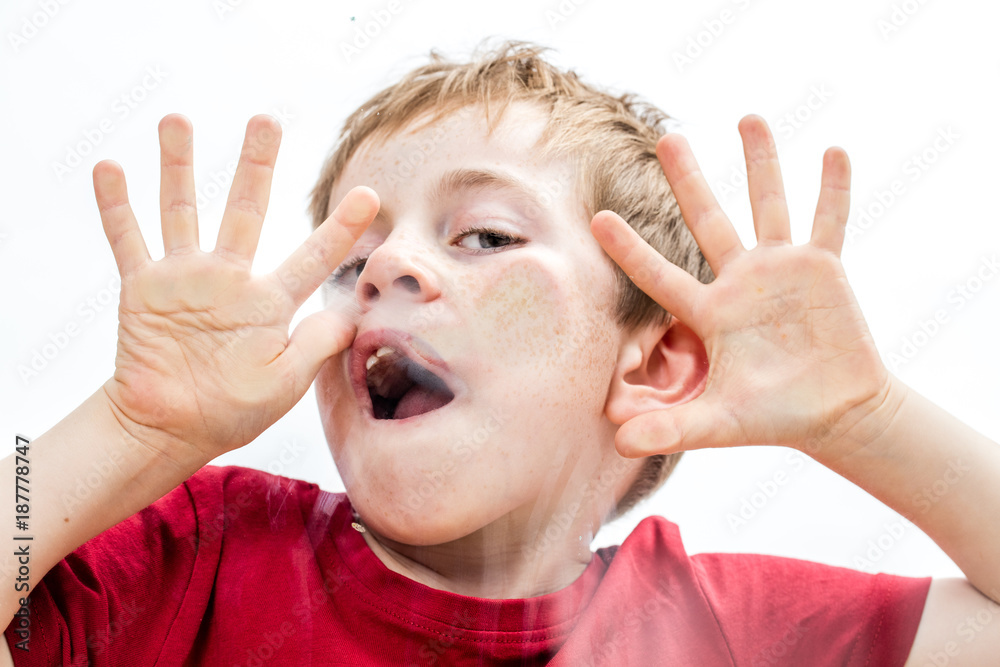 goofy little boy playing silly, touching his face and hands Stock Photo ...