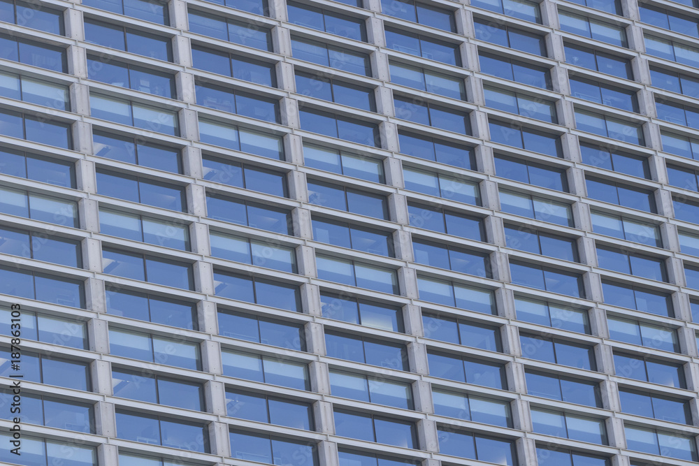 Background image of an office building facade full of glass windows ...