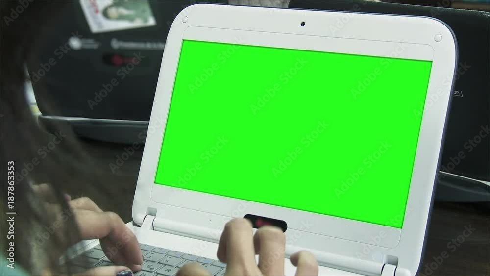 School Girl Using a White Netbook Computer With Green Screen, Close Up ...