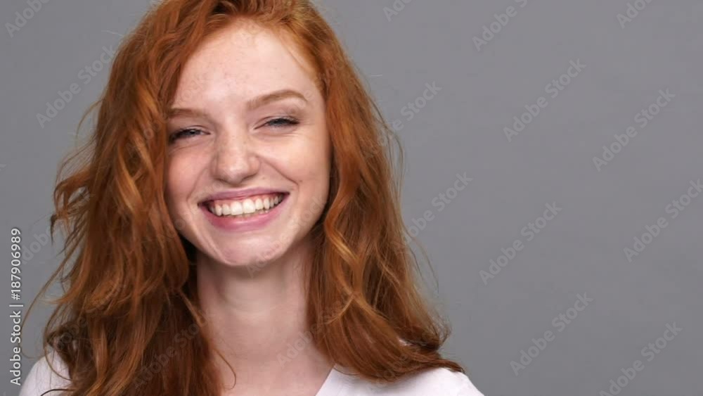Close up view of cheerful mystery ginger woman in t-shirt showing her ...