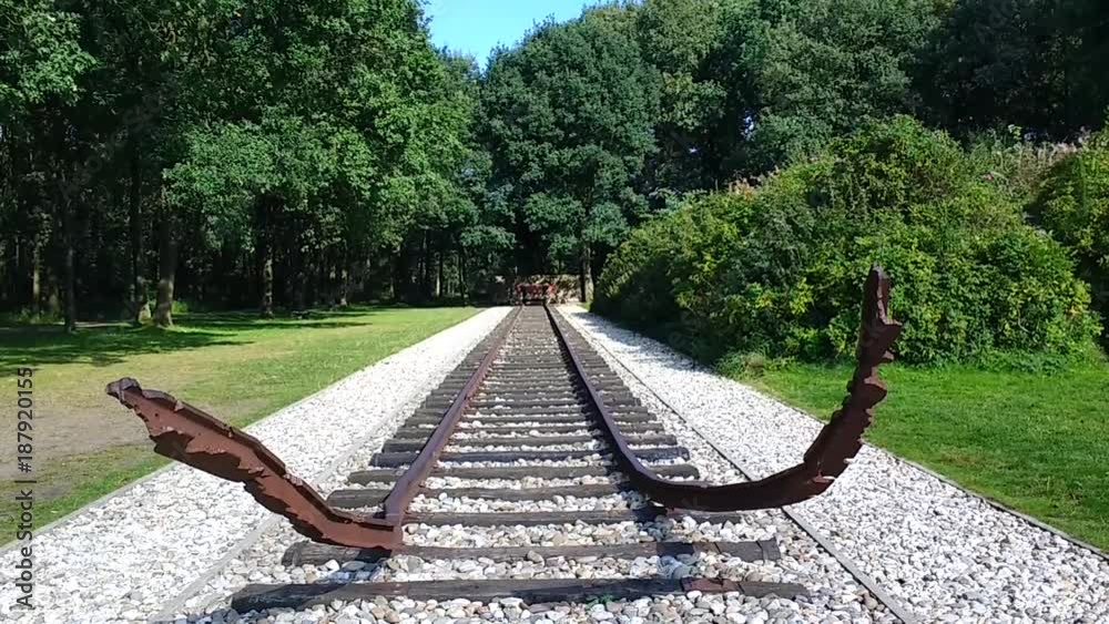 Footage of broken and bent train rail track moving upwards towards sky ...