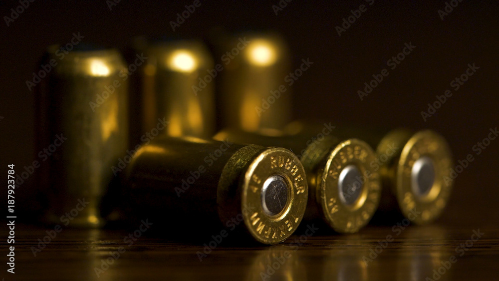 Bullets closeup on black backgrounds. Rubber bullets macro with limited ...