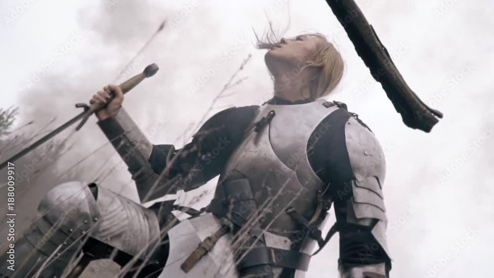 A woman knight looks around on the kneeling side and leaning on the ...