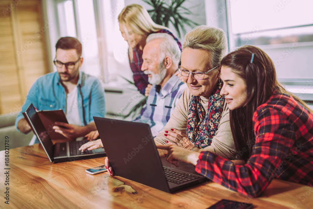 Young Volunteers Help Senior People On The Computer - Stock - GamesAgeddon