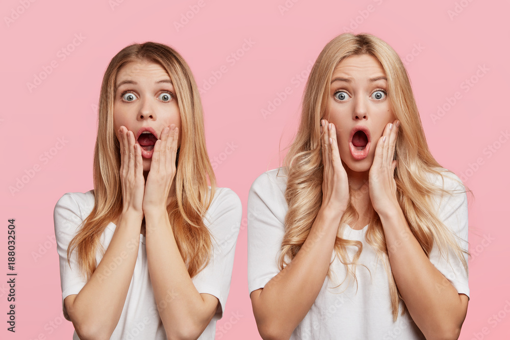 Surprised blonde females look with terrified expressions, being puzzled ...