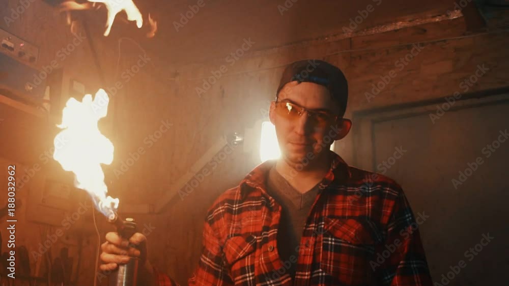 male mechanic in a garage with a gas burner in the hands slow mo Stock ...