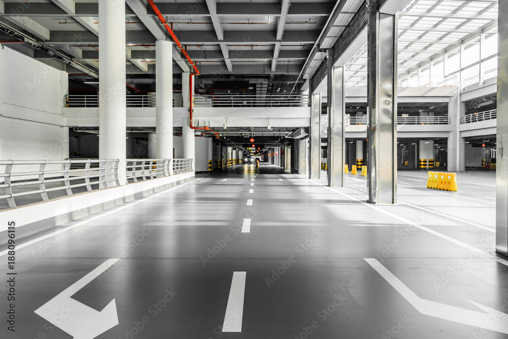 interior of parking garage with car and vacant parking lot in parking ...