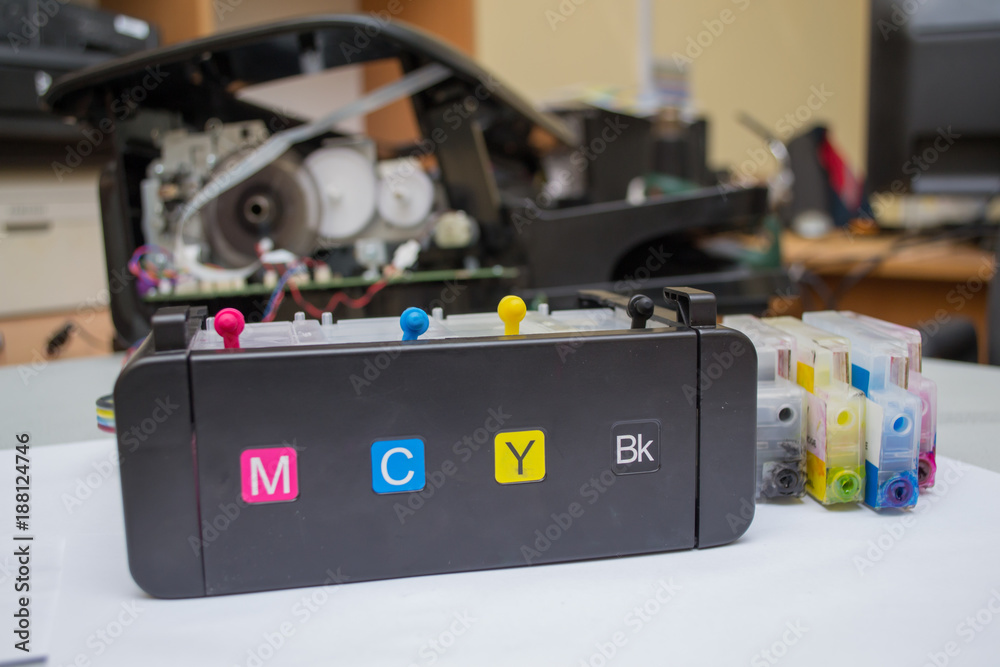 Color cartridges and continuous ink supply system on the background of ...
