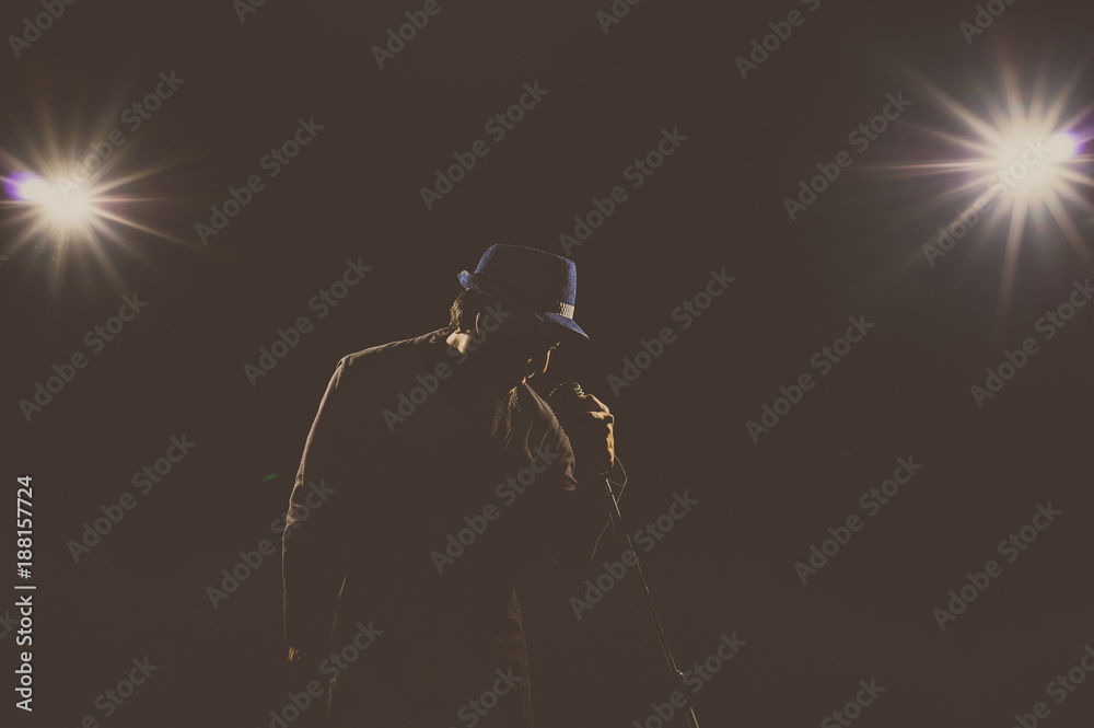 Asian Musician singing a song with microphone on black background with ...