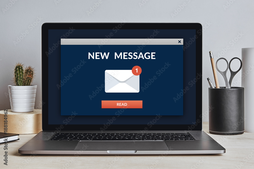 New message notification concept on laptop screen on modern desk. All ...