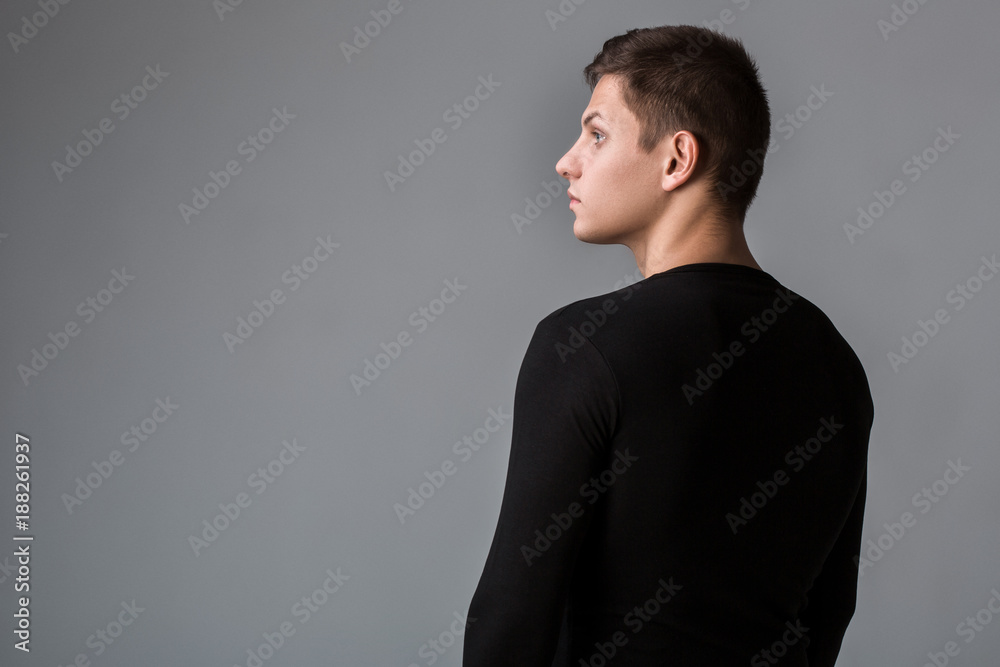 Back view of man in black sweater. Standing young guy. Rear view Stock ...