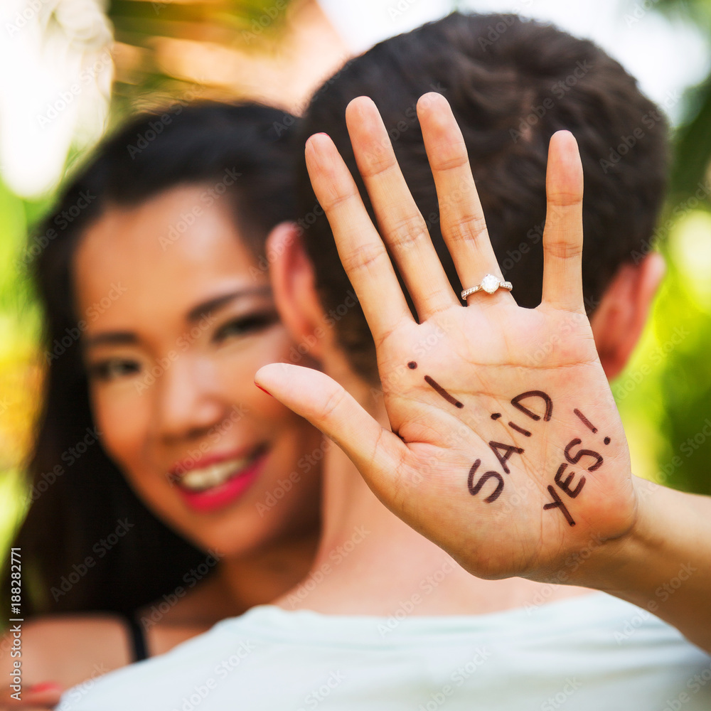 Romantic portrait of young interracial couple in love hugs. Just got ...