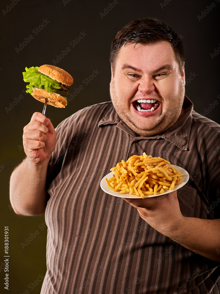 Breakfast for overweight person.e of fat man eating fast food hamberger ...