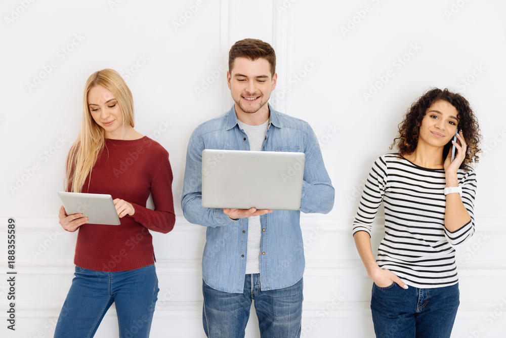 Types of communication. Cheerful man keeping smile on his face and ...