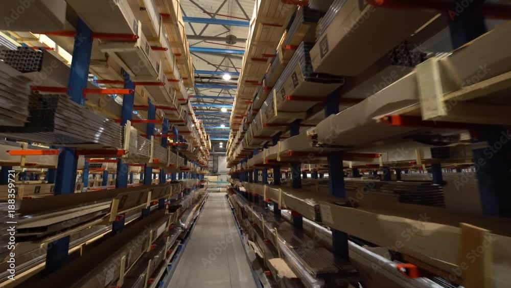 Racks with window profiles in a warehouse. The camera moves along racks ...