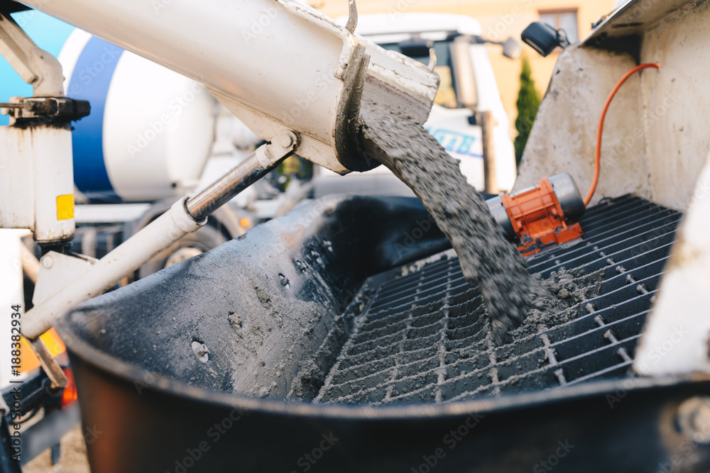 pouring concrete from a concrete mixer to the pump - pouring concrete ...