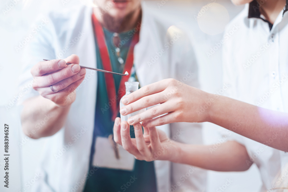 Learning and research. Scaled up shot of a male scientists adding a ...