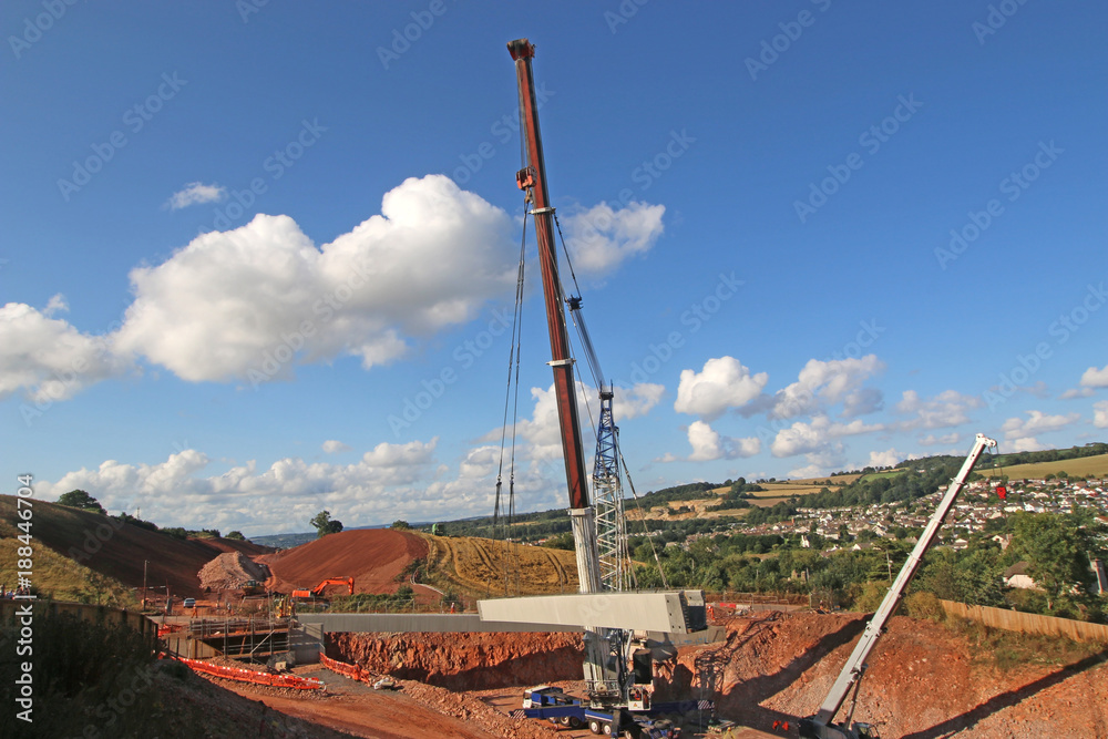 Crane lifting a concrete bridge beam Stock Photo | Adobe Stock