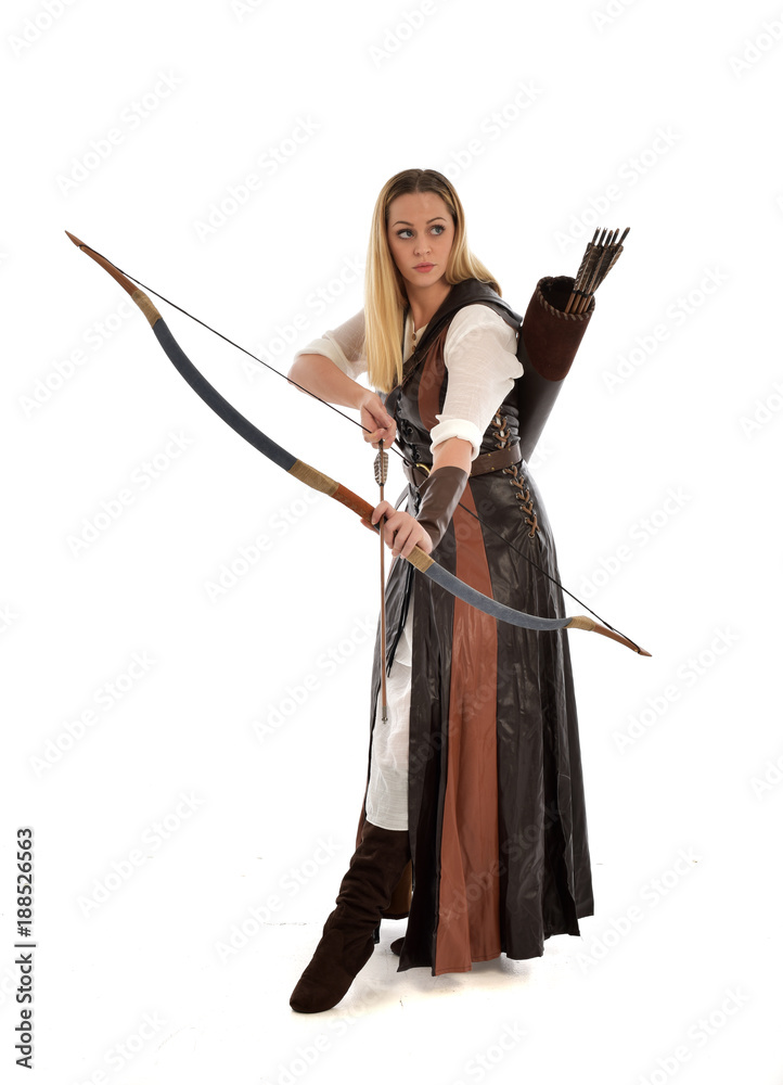 full length portrait of girl wearing brown fantasy costume, holding a ...