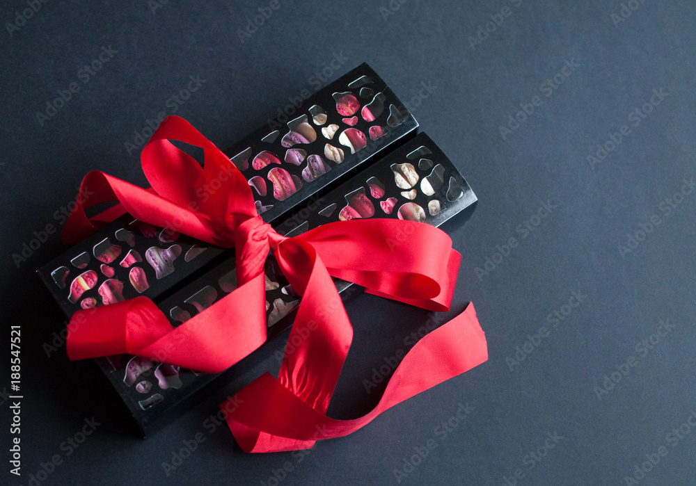 macaroon on black background with red ribbon, colorful almond cookies ...