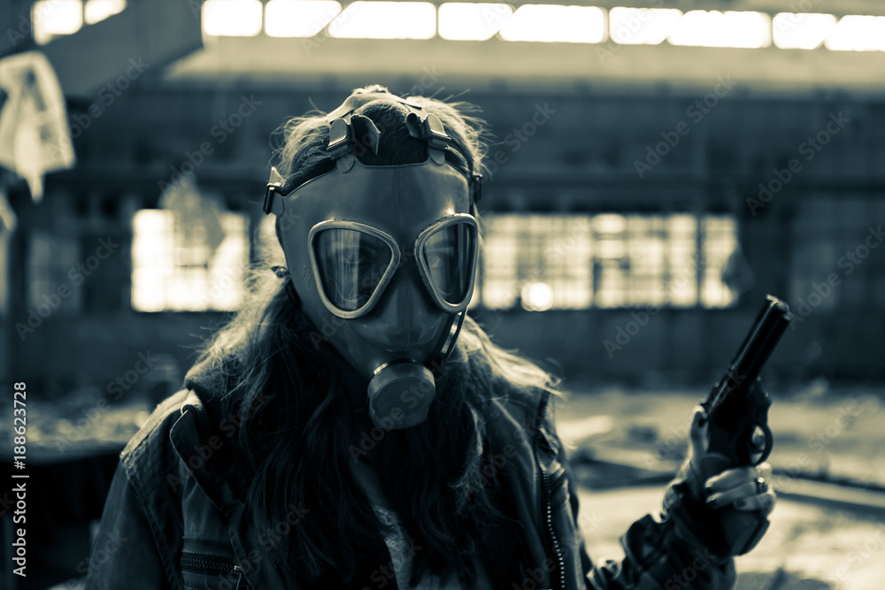 Armed girl with a gas mask Stock Photo | Adobe Stock