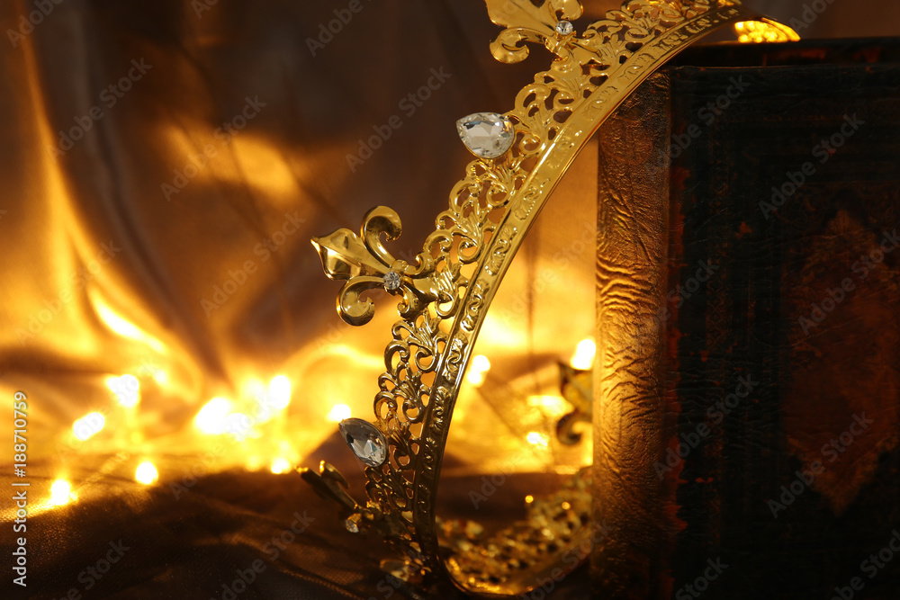 low key image of beautiful queen/king crown on old book. fantasy ...