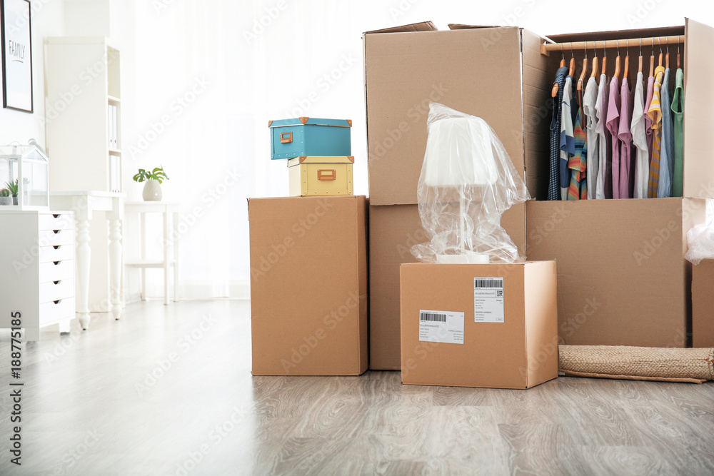 Wardrobe boxes with clothes indoors Stock Photo | Adobe Stock