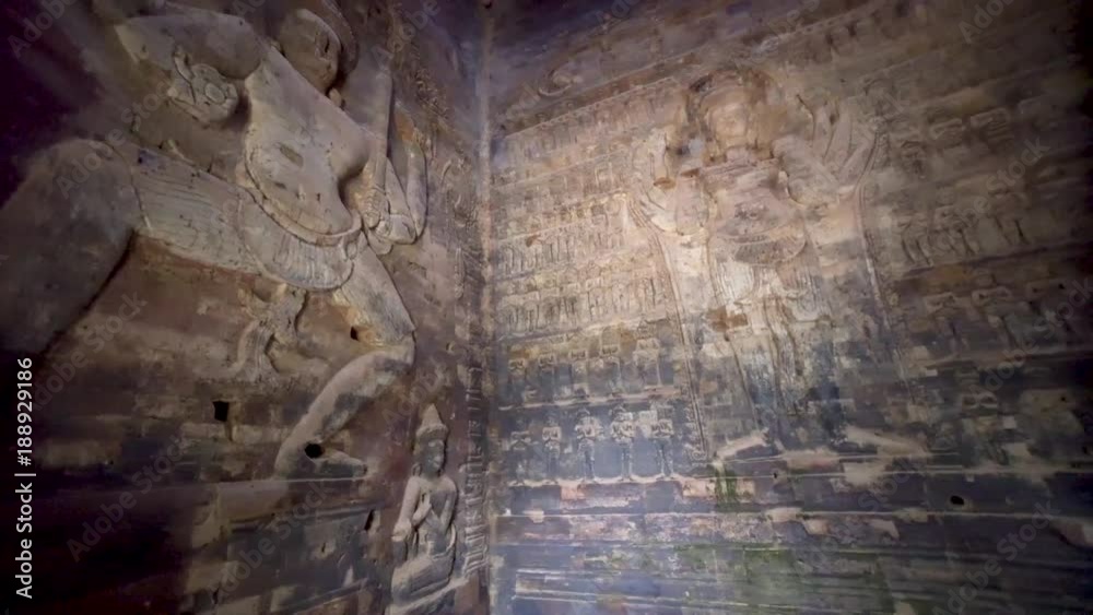 Panning around the interior showing eight-armed Vishnu stands stiffly ...