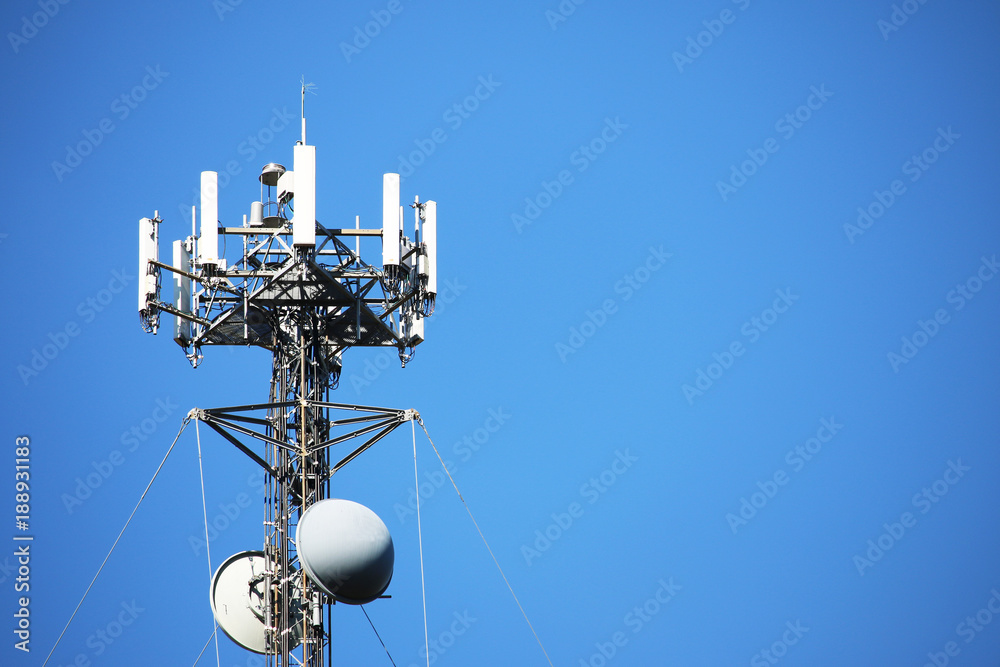 Telecommunications tower set against a blue sky with ample copy space ...