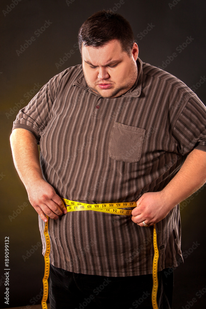 Man Belly Fat With Tape Measure Weight Loss Around Body On Black Man Belly Fat With Tape Measure Weight Loss Around Body On Black