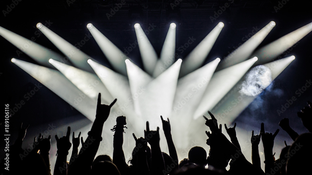 Crowd raising their hands and enjoying a great rock and metal concert ...