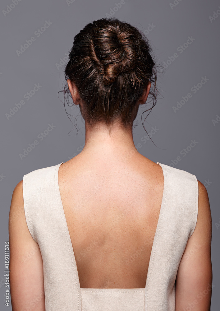 Head and shoulders of a young woman from the back side. Female hair ...