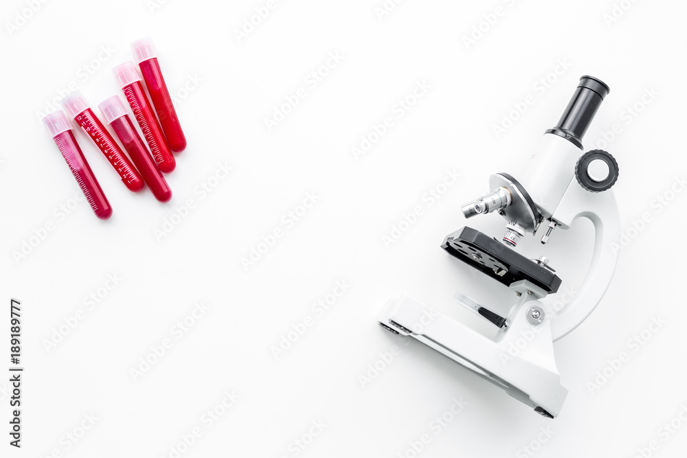 Blood analysis in clinacal lab. Test tubes near microscope on white ...