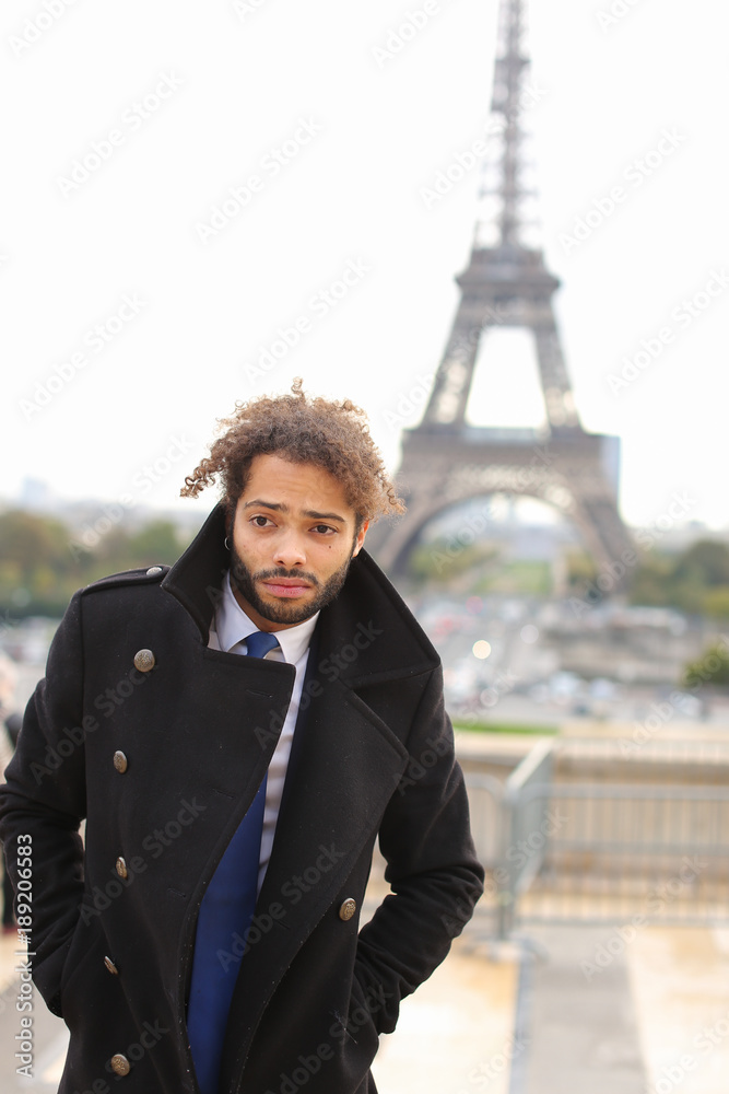 Mulatto male model smiling near Eiffel Tower. Stock Photo | Adobe Stock
