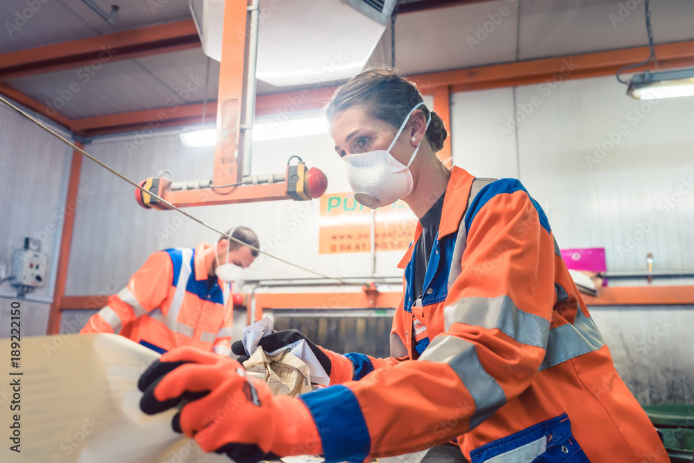 Workers in sorting room of garbage recycling facility Stock Photo ...